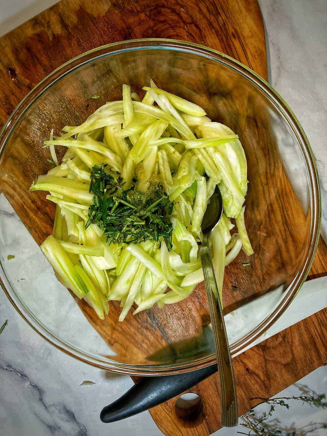 sliced fennel in medium bowl with herbs | Spice and Life